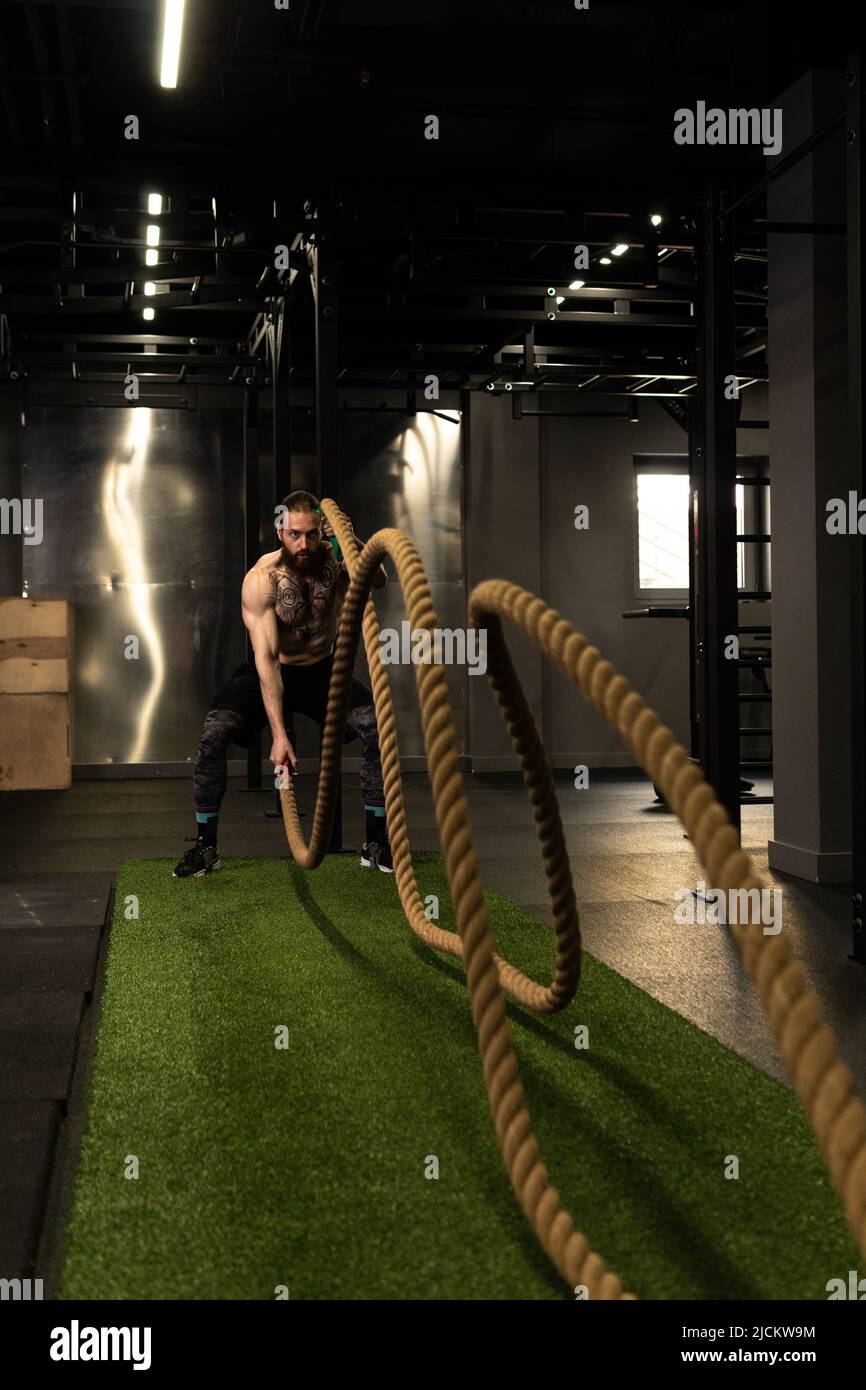 Rope man fitness gym beard training battle fit sport exercise, concept ...