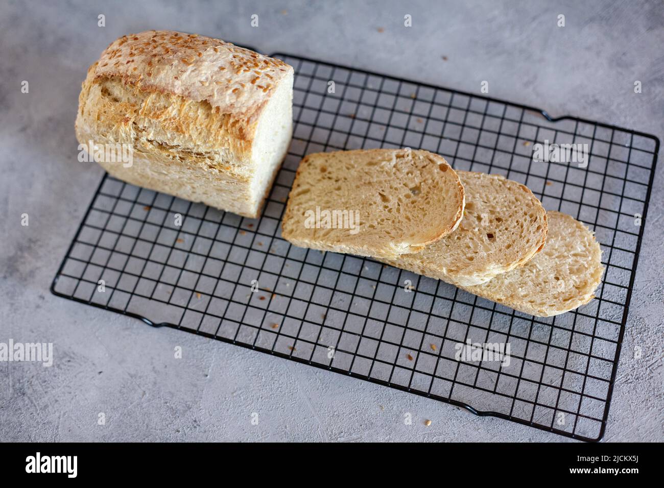 Baked Ruddy Wheat Brick Bread sourdough and slice with flax seeds on a ...