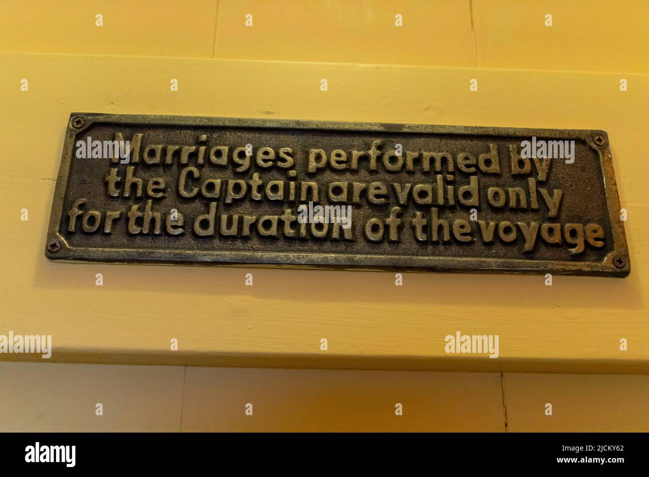 A metal sign reads, "Marriages performed by the captain are valid only ...