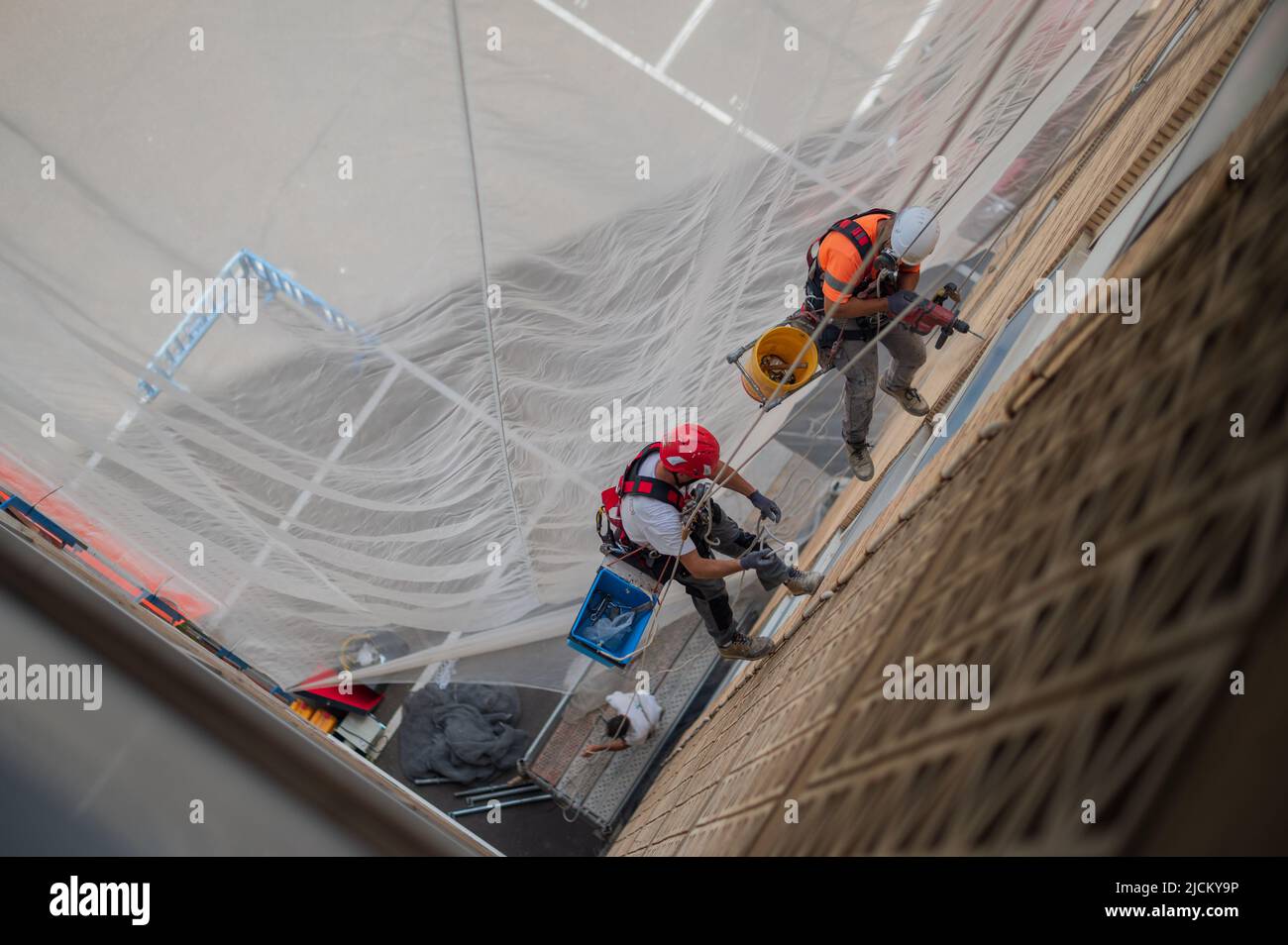 Industrial climbers at work in residential building Stock Photo - Alamy
