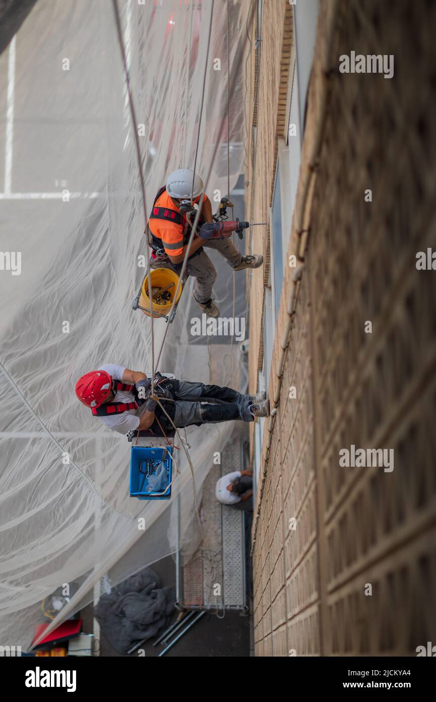Industrial climbers at work in residential building Stock Photo - Alamy