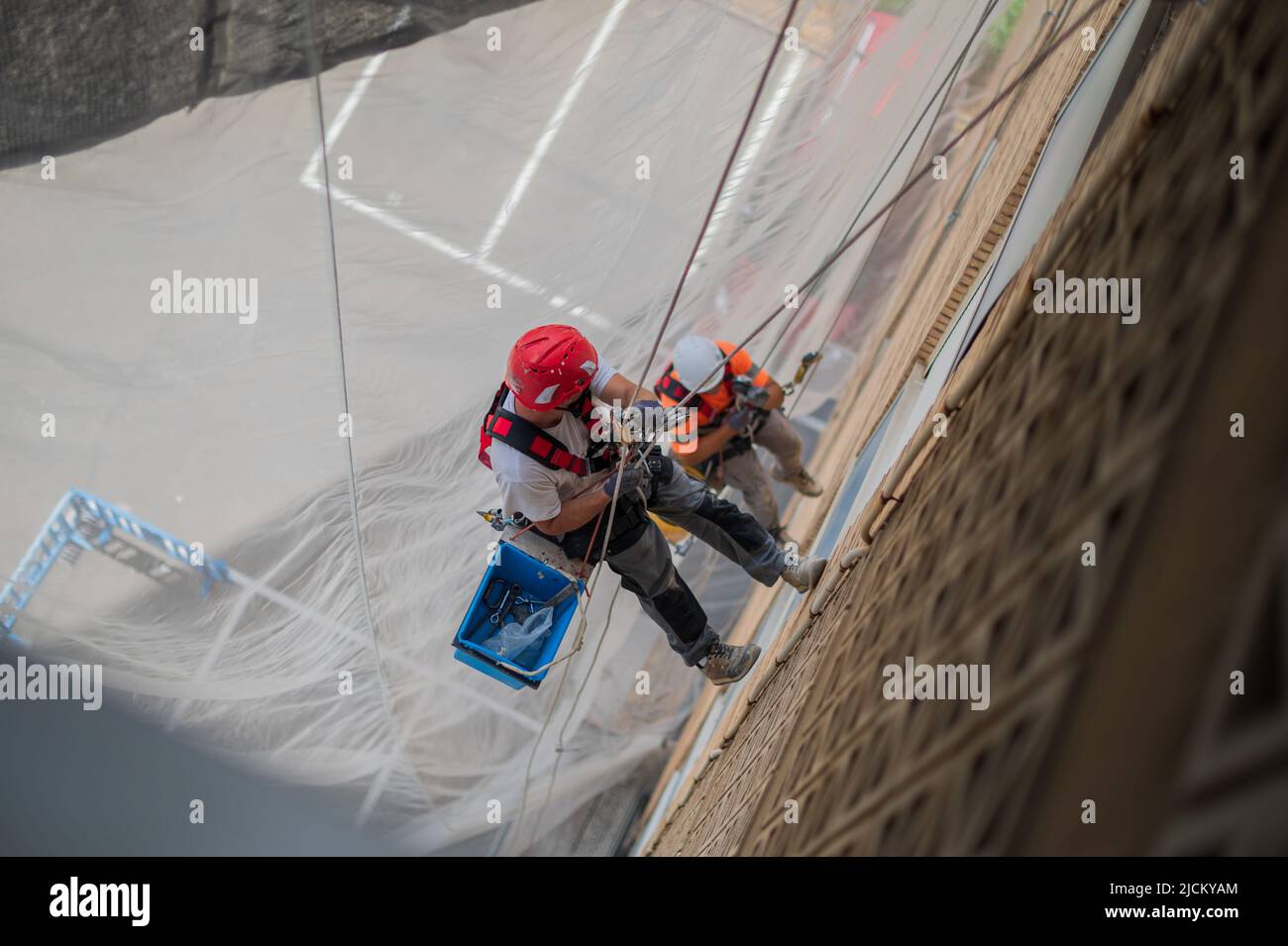 Industrial climbers at work in residential building Stock Photo - Alamy