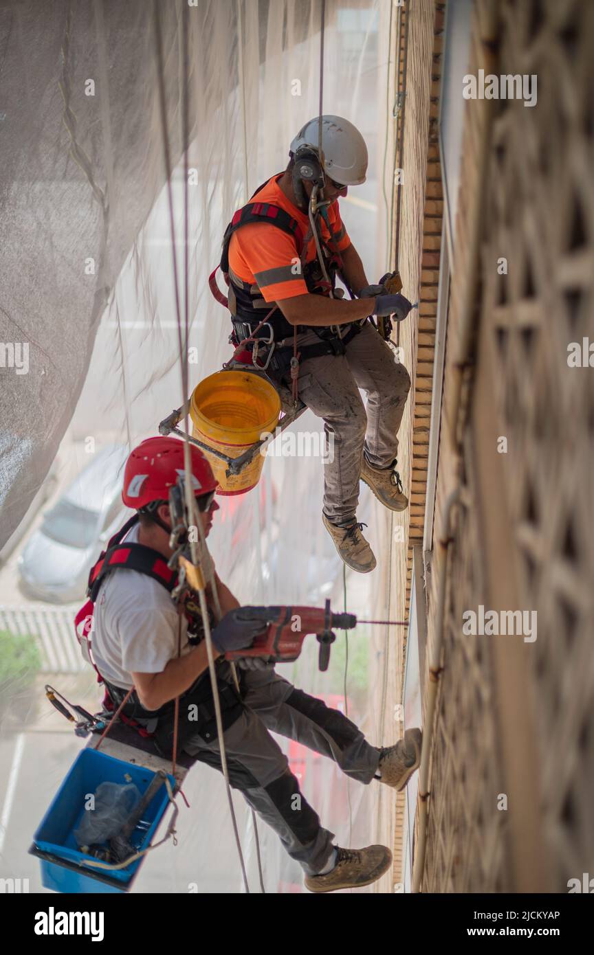 Industrial climbers at work in residential building Stock Photo - Alamy