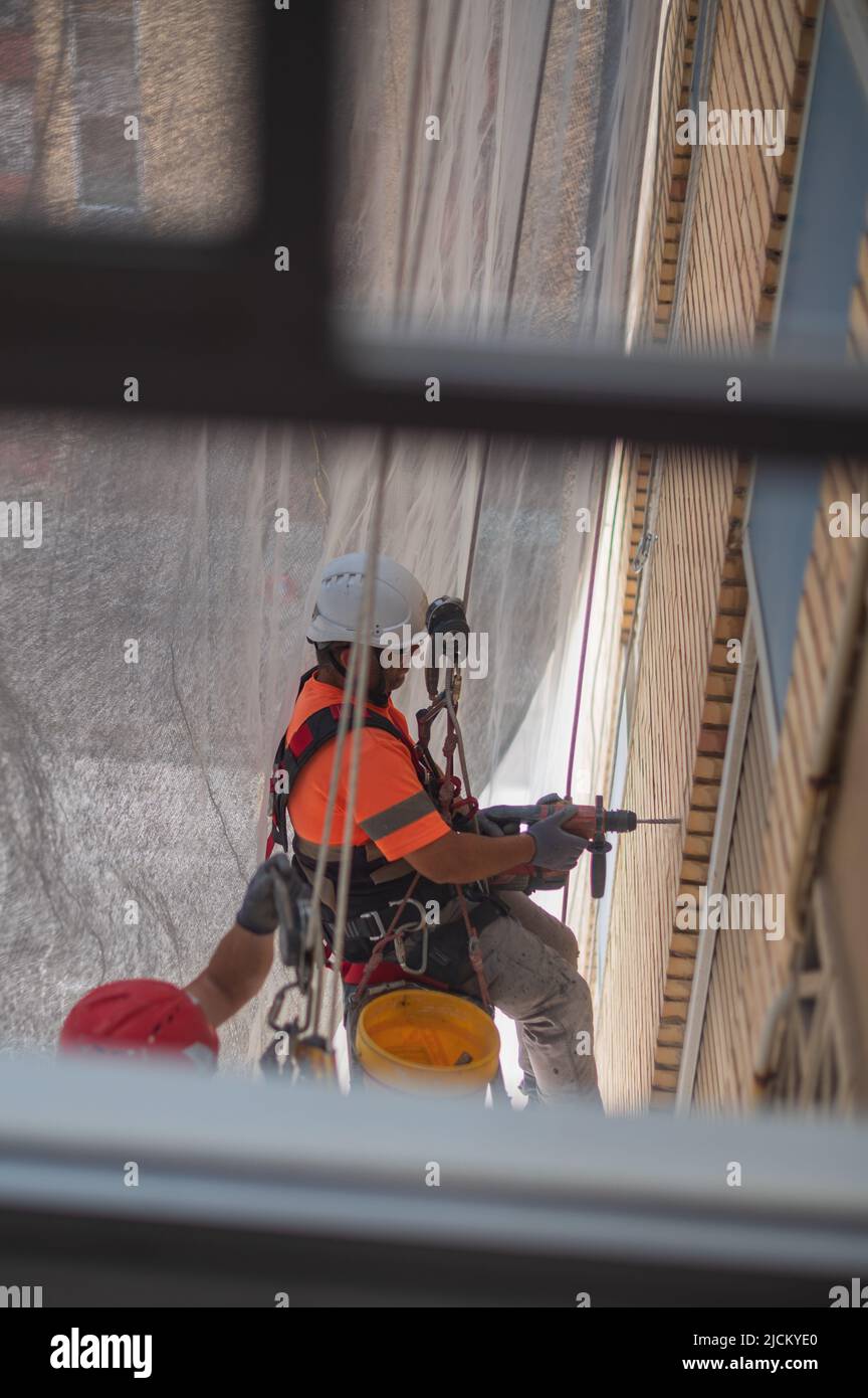 Industrial climbers at work in residential building Stock Photo - Alamy