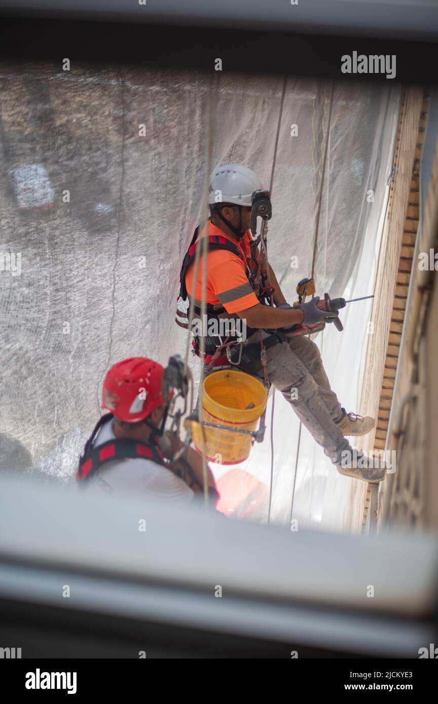 Industrial climbers at work in residential building Stock Photo - Alamy