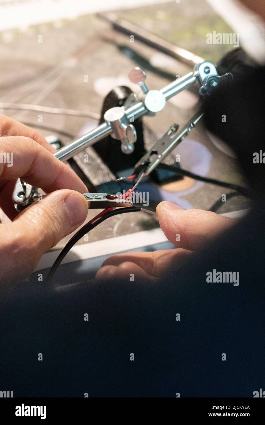 Closeup of macro of a man doing electricity work or putting wires ...