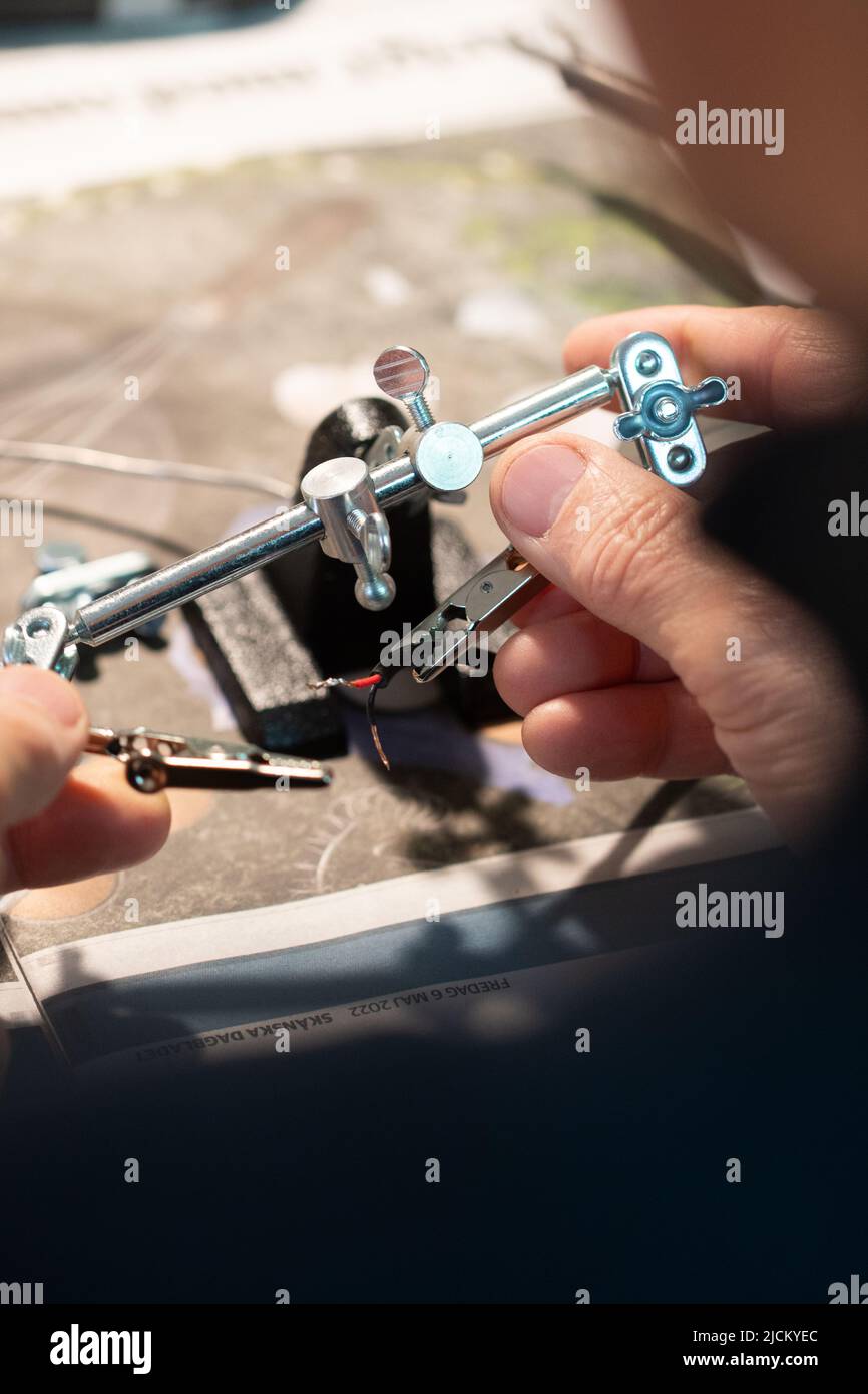 Closeup of macro of a man doing electricity work or putting wires ...
