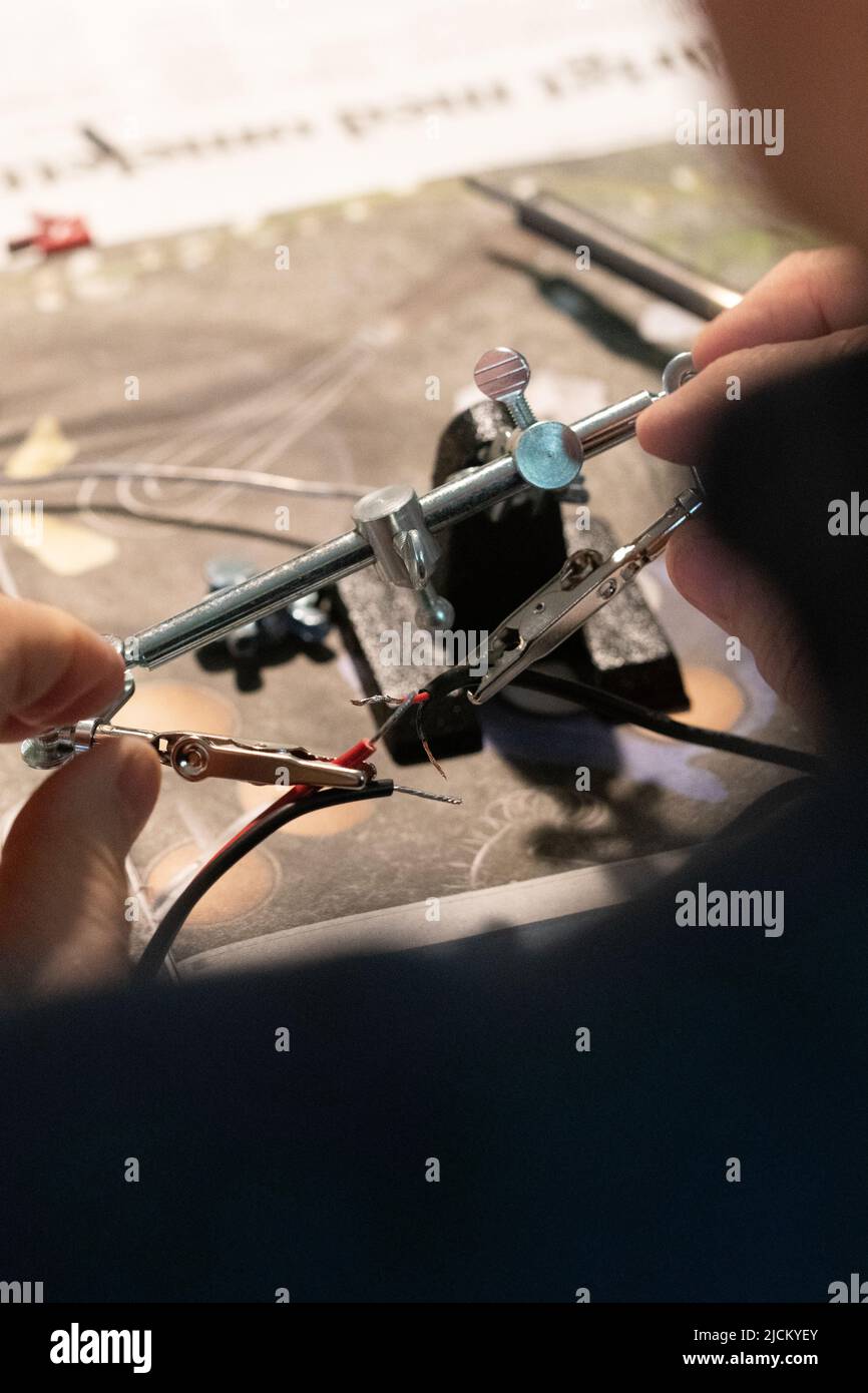 Closeup of macro of a man doing electricity work or putting wires ...