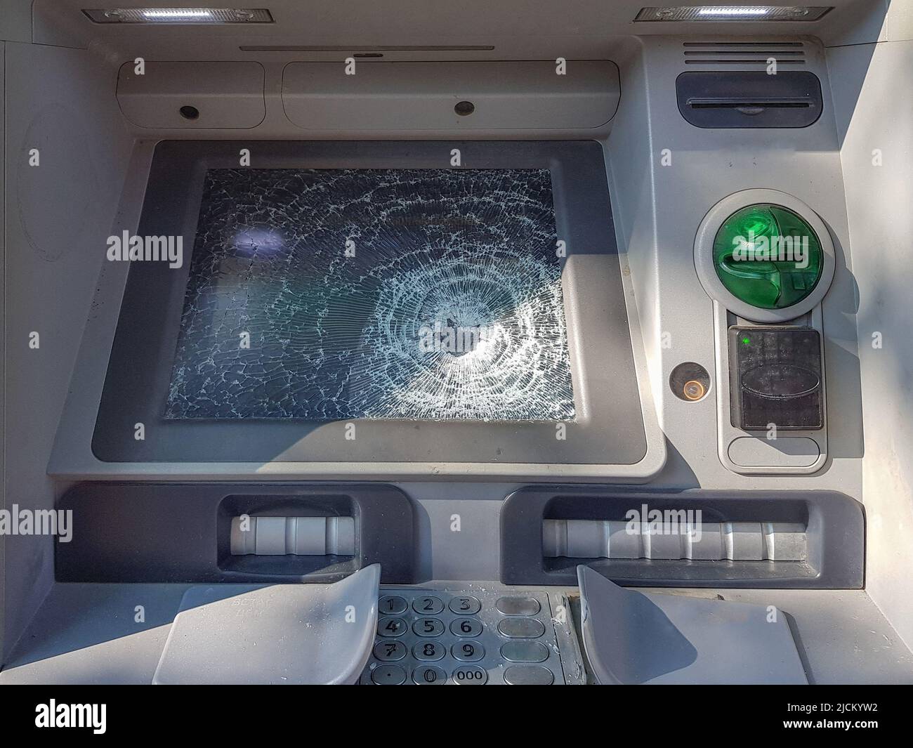 ATM machine with broken glass close up Stock Photo - Alamy
