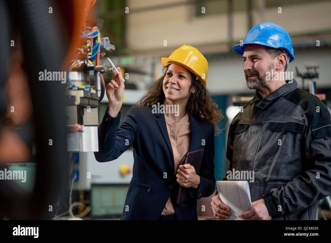 Female engineering manager and mechanic worker doing routine check up ...
