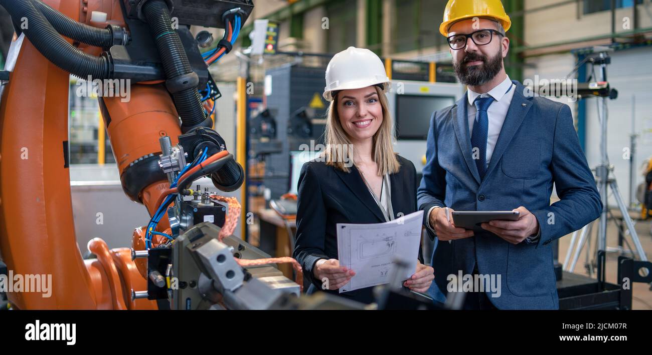 Chief engineer and project manager in modern industrial factory with ...