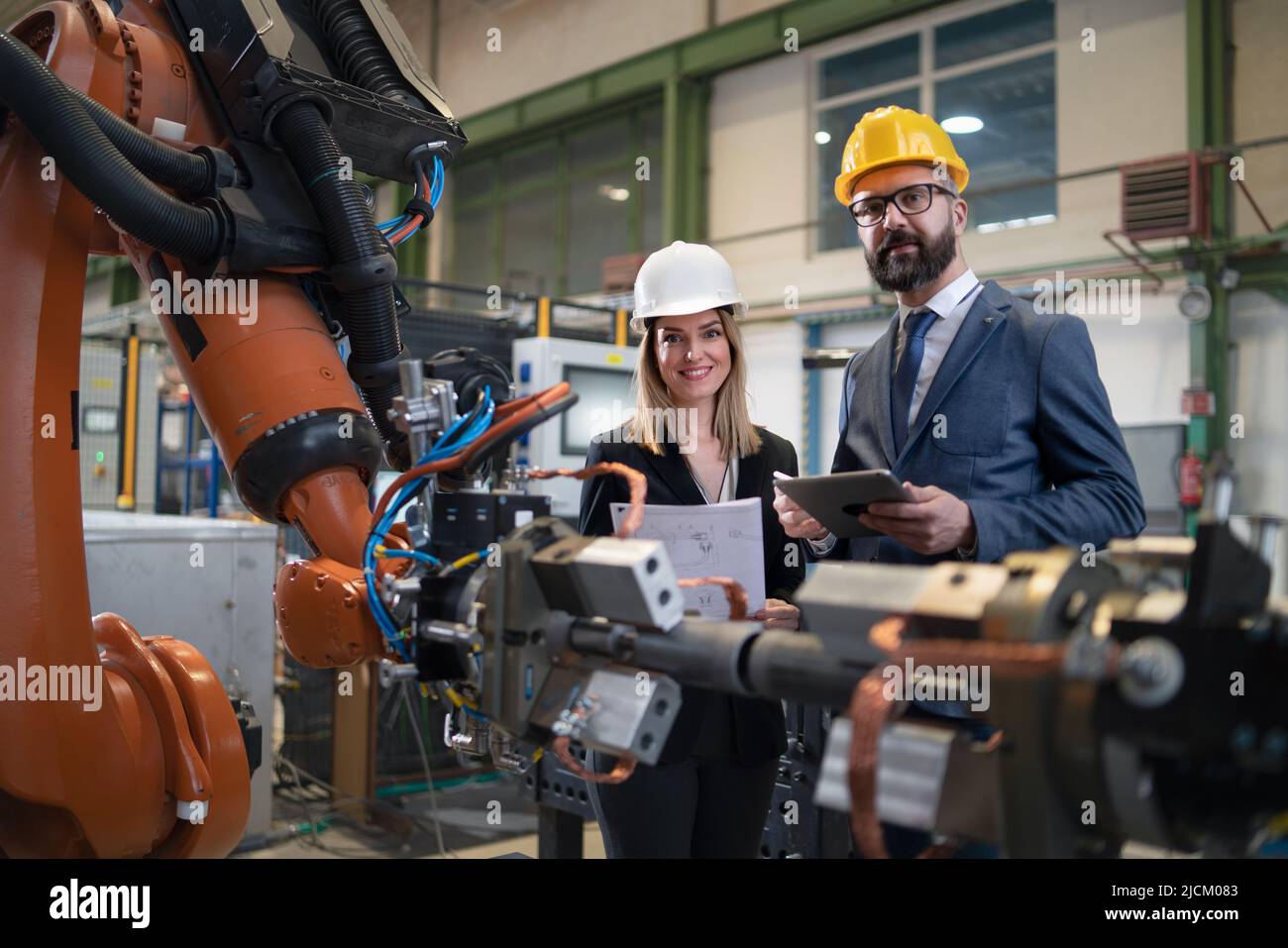 Chief engineer and project manager in modern industrial factory with ...