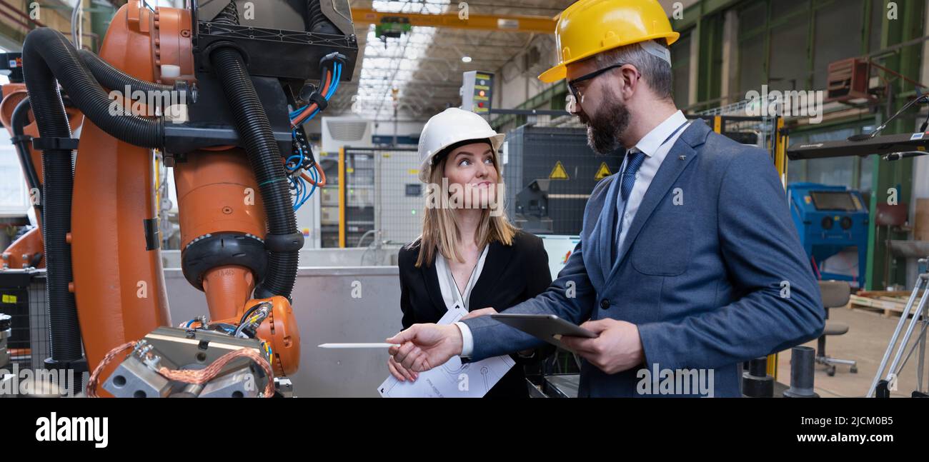 Chief engineer and project manager in modern industrial factory with ...