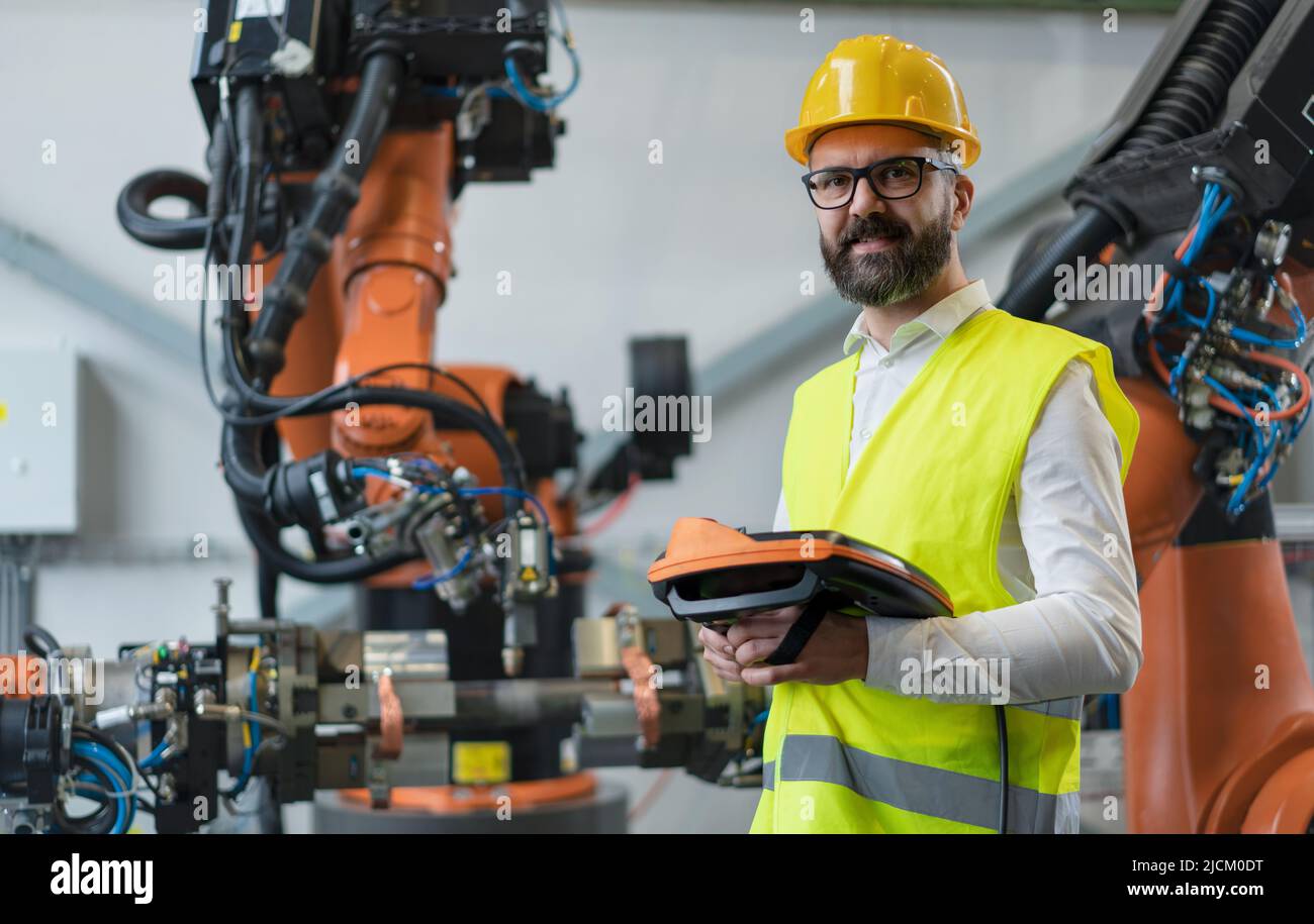 Automation engineer holding scanner in industrial in factory Stock ...