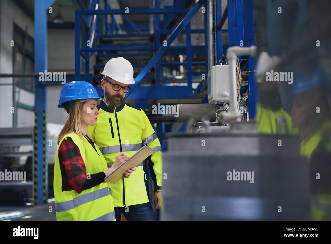 Engineering manager and mechanic worker doing routine check up in ...