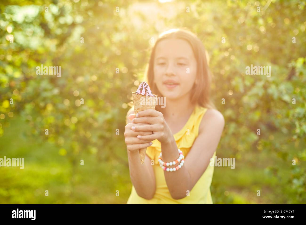 Happy girl with braces eating italian ice cream cone smiling while ...