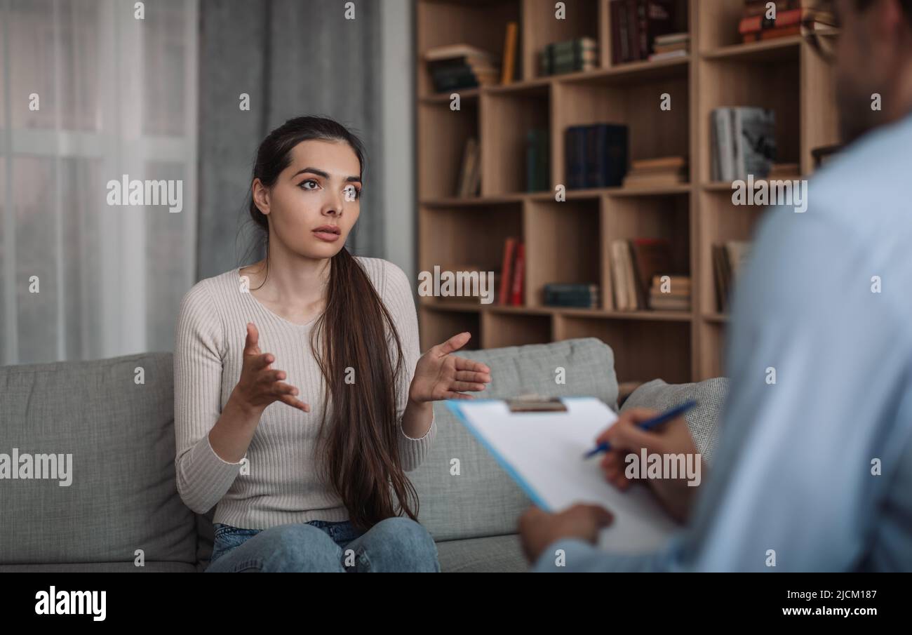 Unhappy sad emotional european millennial woman client talking to ...