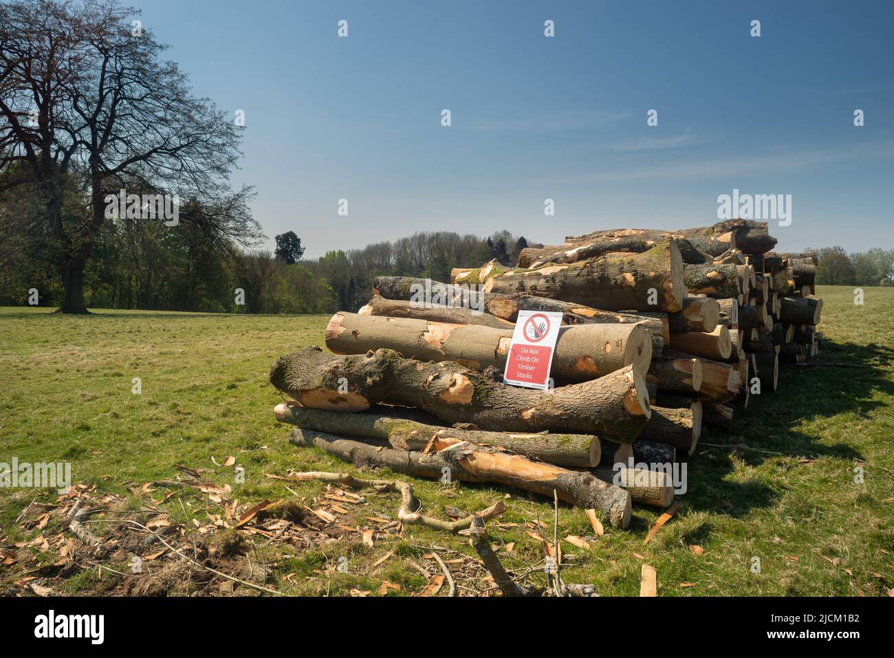 Dangerous stack of heavy sawn timber with warning sign to keep off in ...