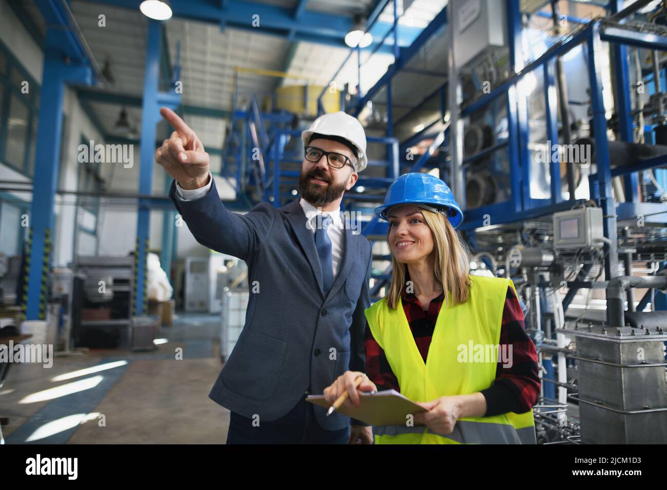 Engineering manager and mechanic worker doing routine check up in ...