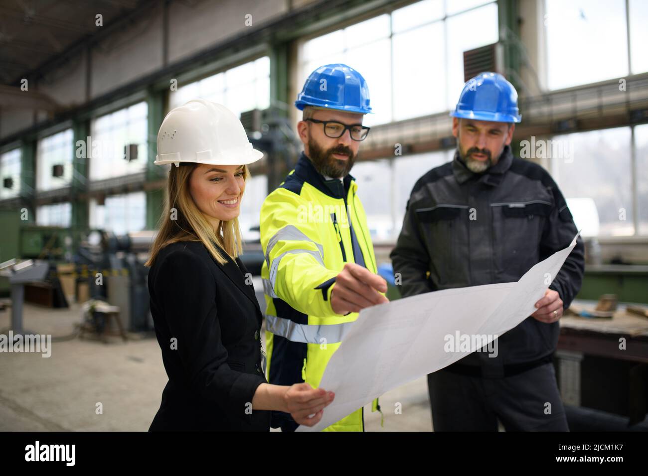 Manager supervisor, engineer and industrial worker in uniform ...