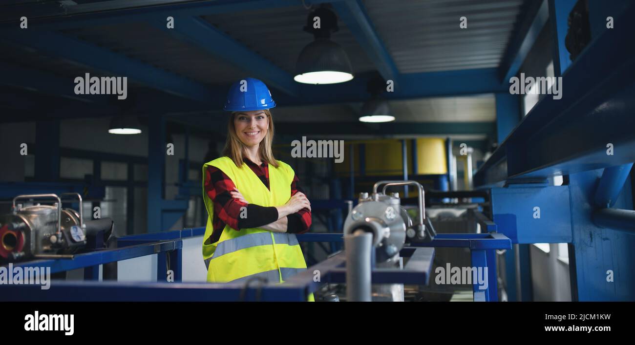 Portrait of female engineer working in industrial factory Stock Photo ...