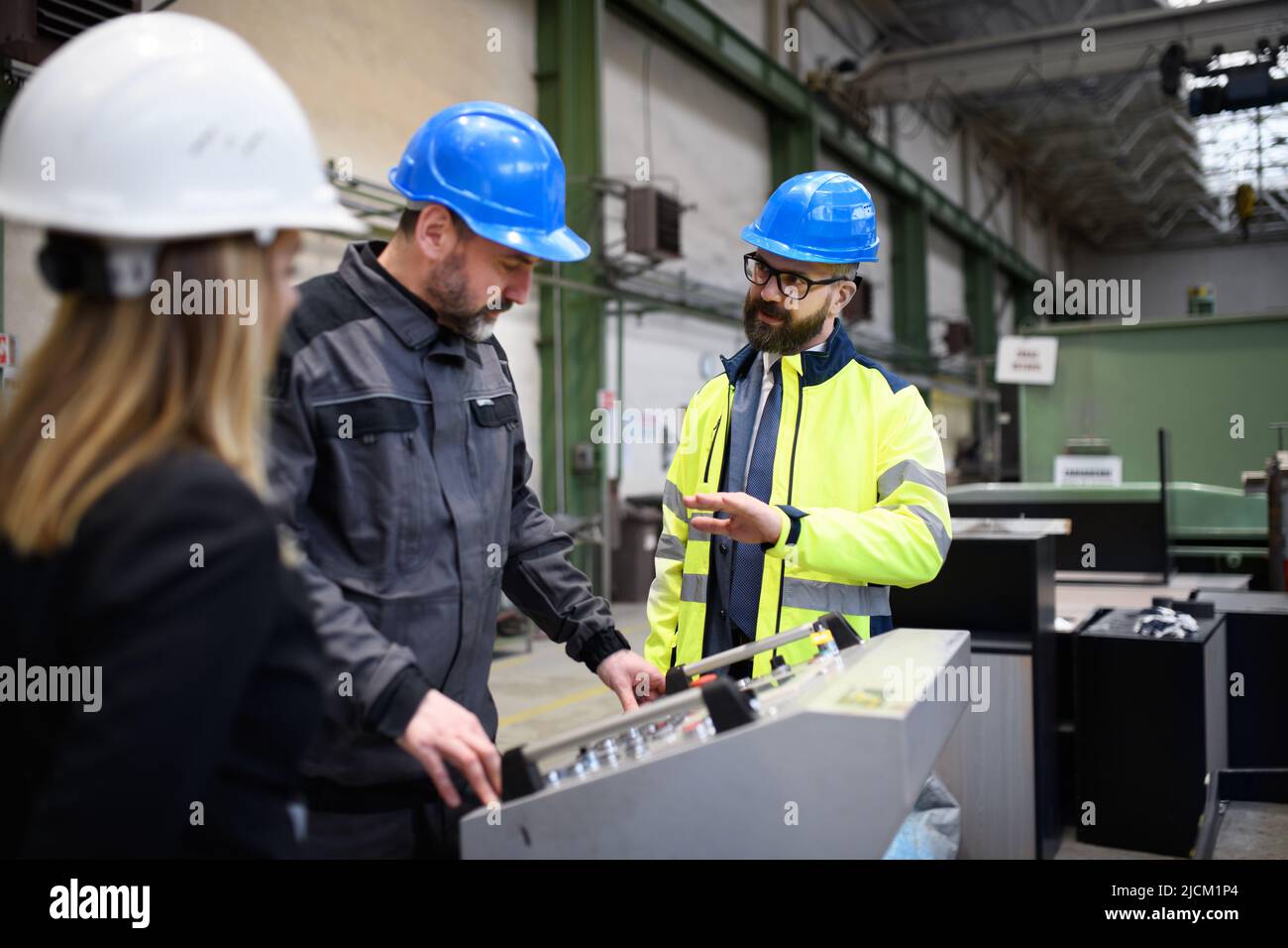 Manager supervisors and industrial worker in uniform doing control in ...