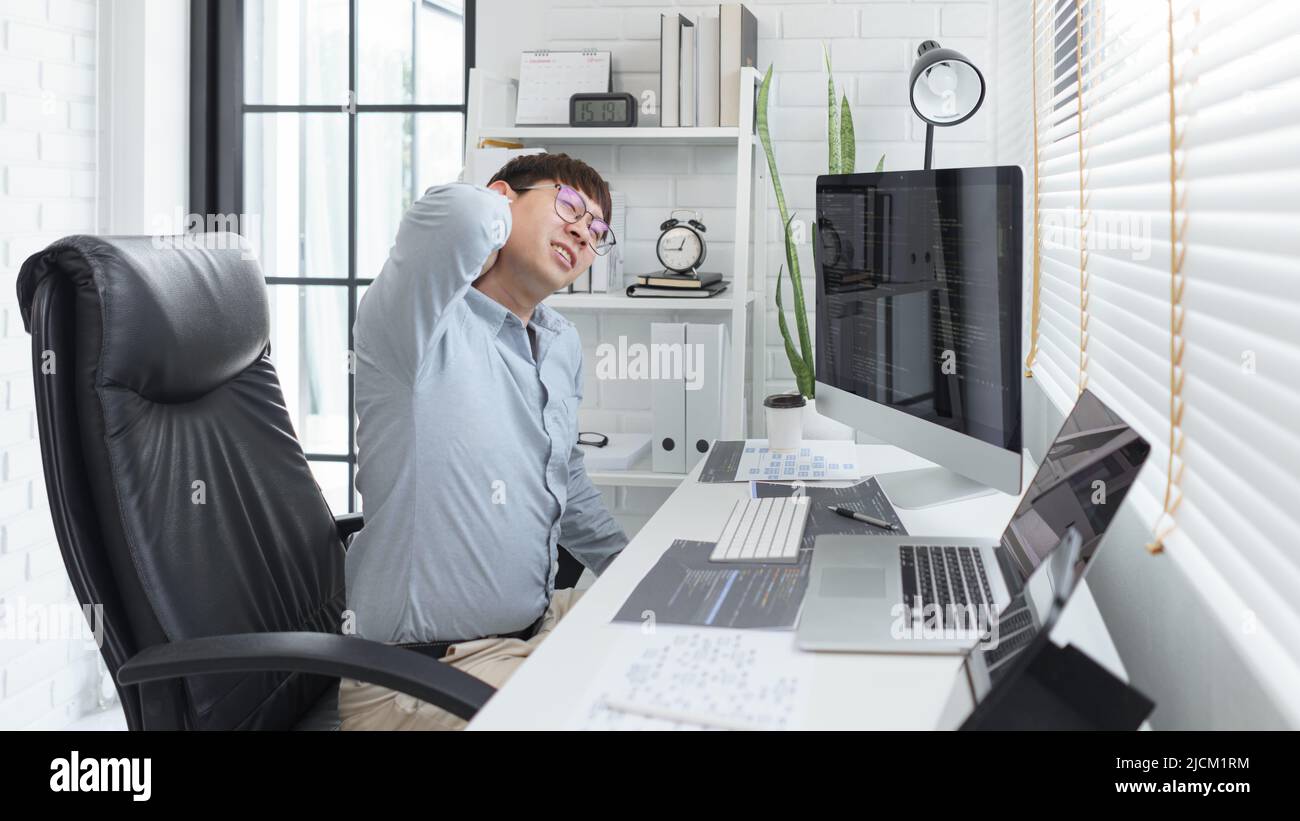 Software development concept, Male programmer suffering neck pain after ...