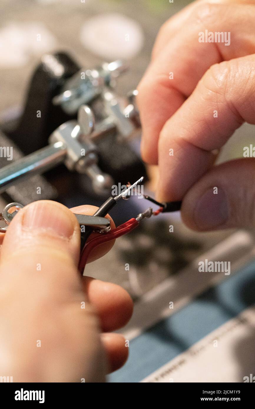 Closeup of macro of a man doing electricity work or putting wires ...
