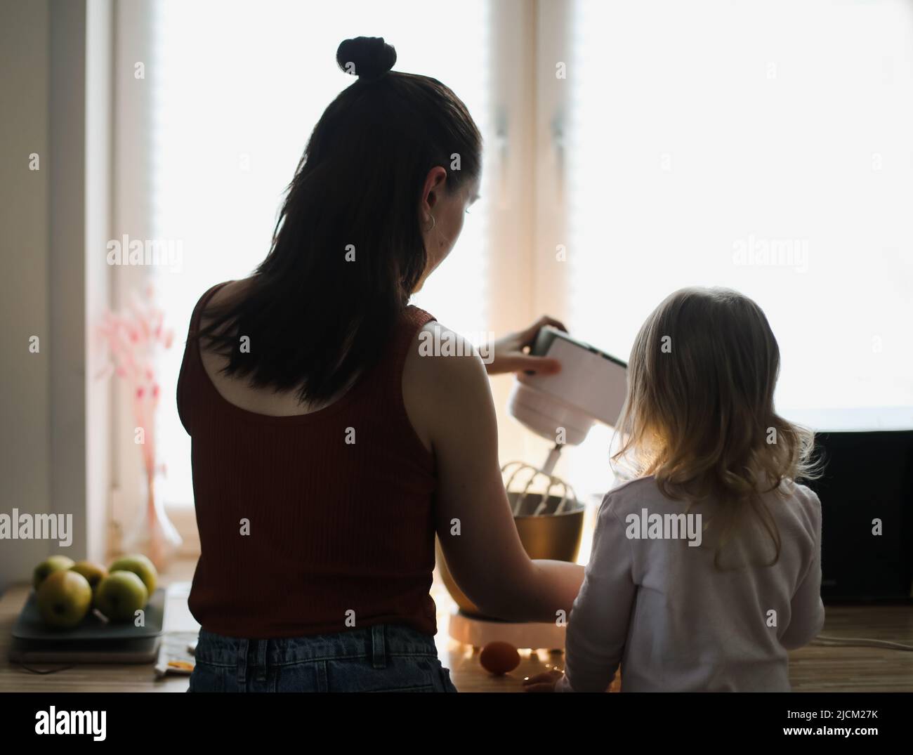 Girl helping mom in kitchen hi-res stock photography and images - Alamy