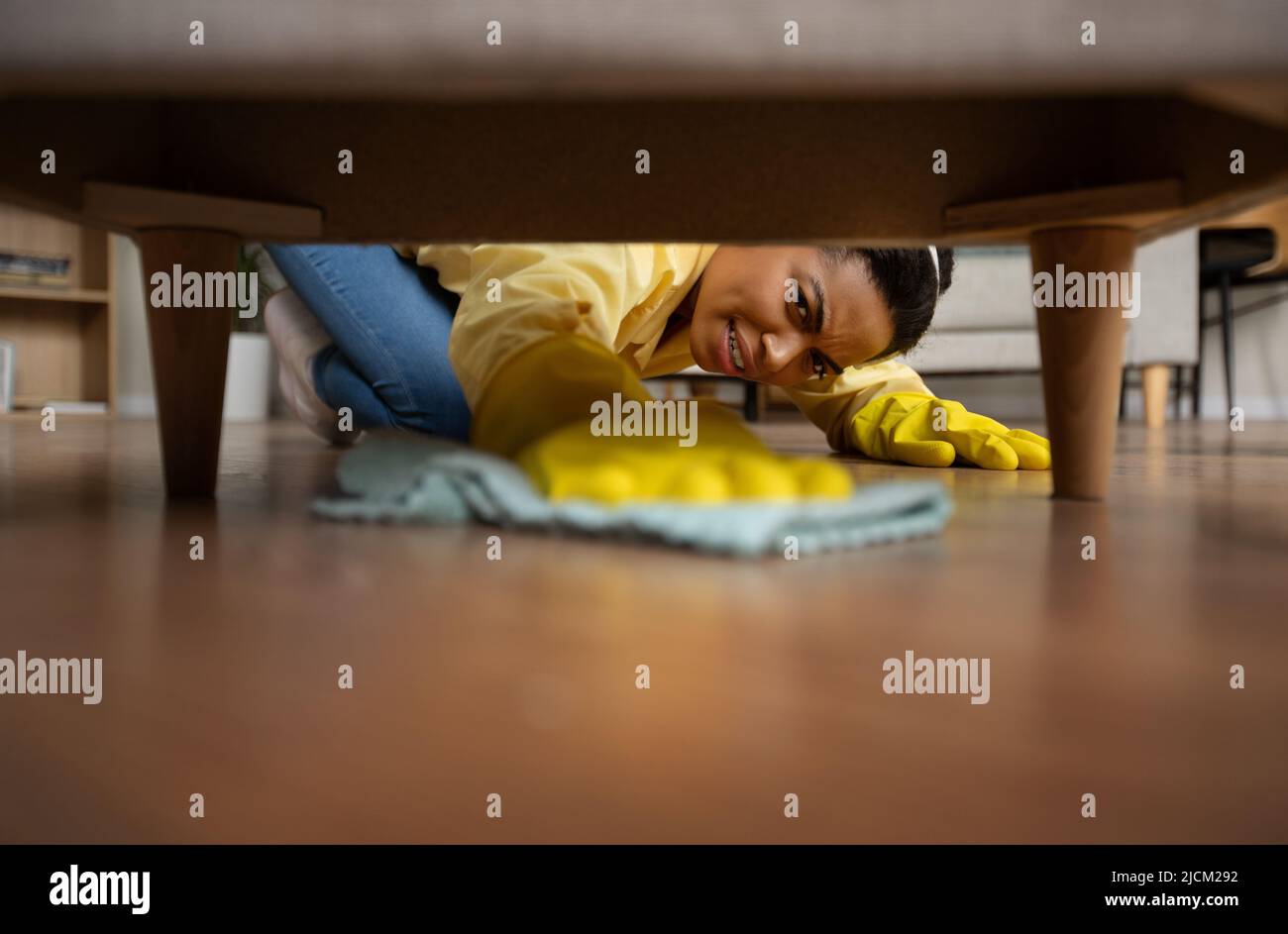 Unhappy African Lady Mopping And Dusting Floor With Rag Indoor Stock ...