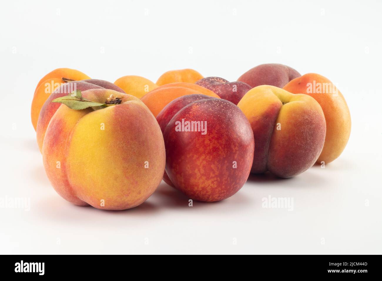 Peaches, nectarines and apricots on bright background. Close up view ...