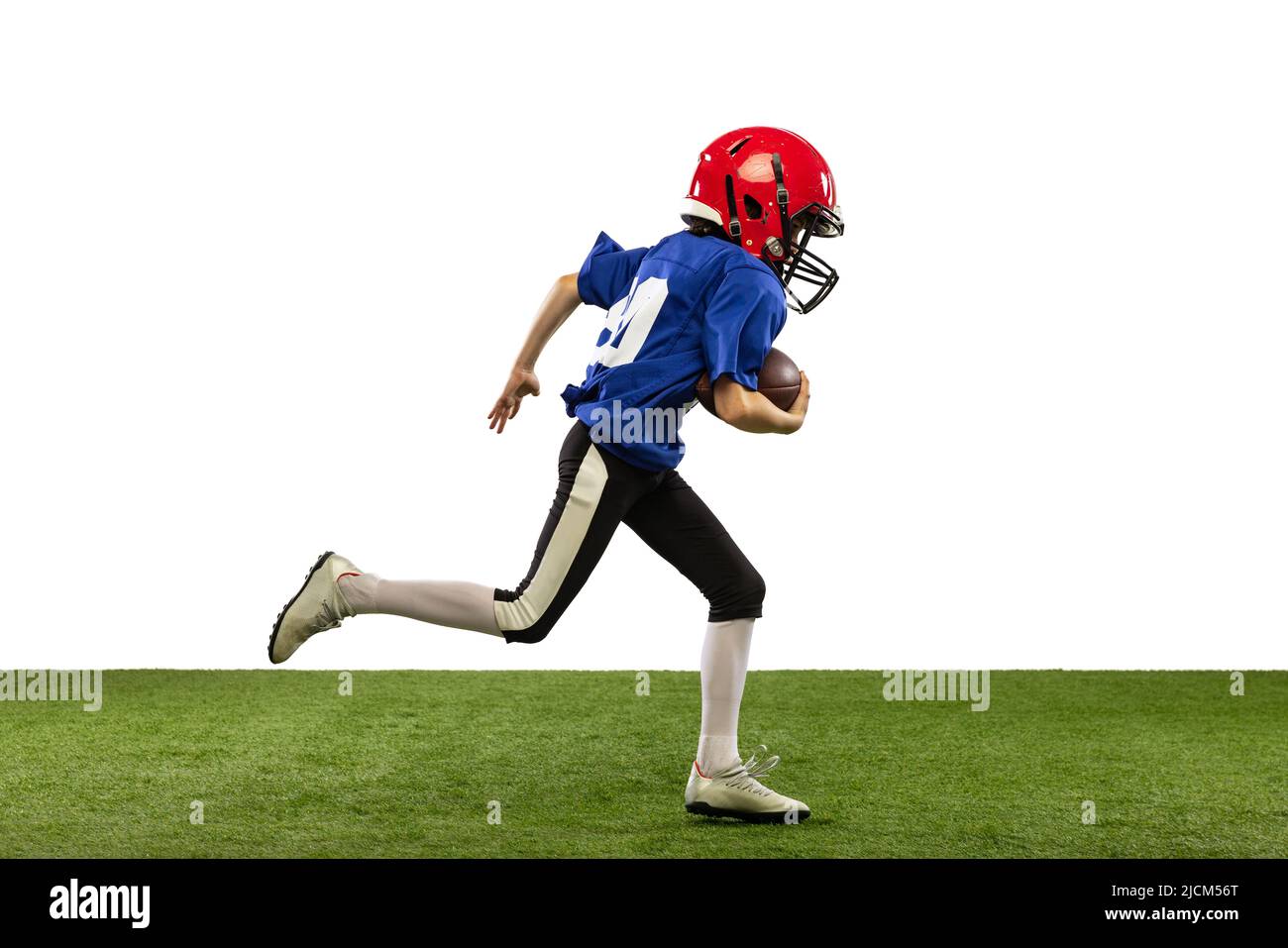 Dynamic portrait of little boy, beginner player of american football ...