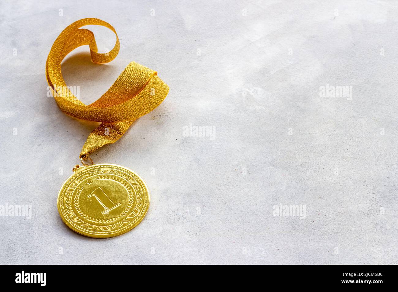 Gold medal first place on ribbon. Winner or champion trophy Stock Photo ...