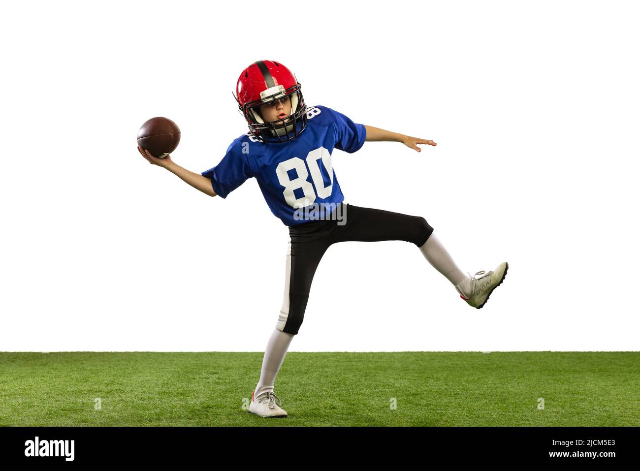 Sportive little boy in sports uniform and equipment playing american ...