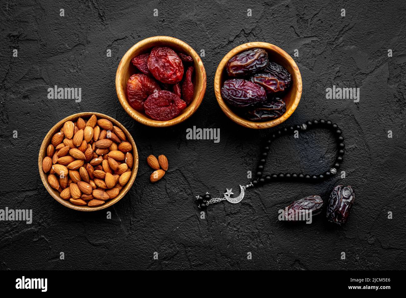 Dates fruits and islamic rosary with star and crescent. Ramadan Kareem ...