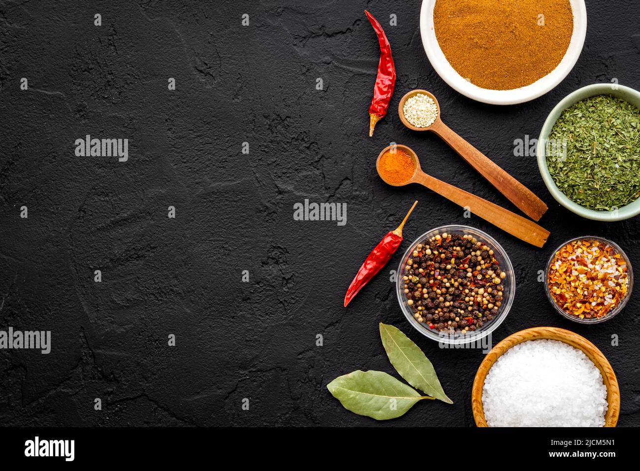 Cooking ingredients - colorful spices and herbs in bowls, top view ...