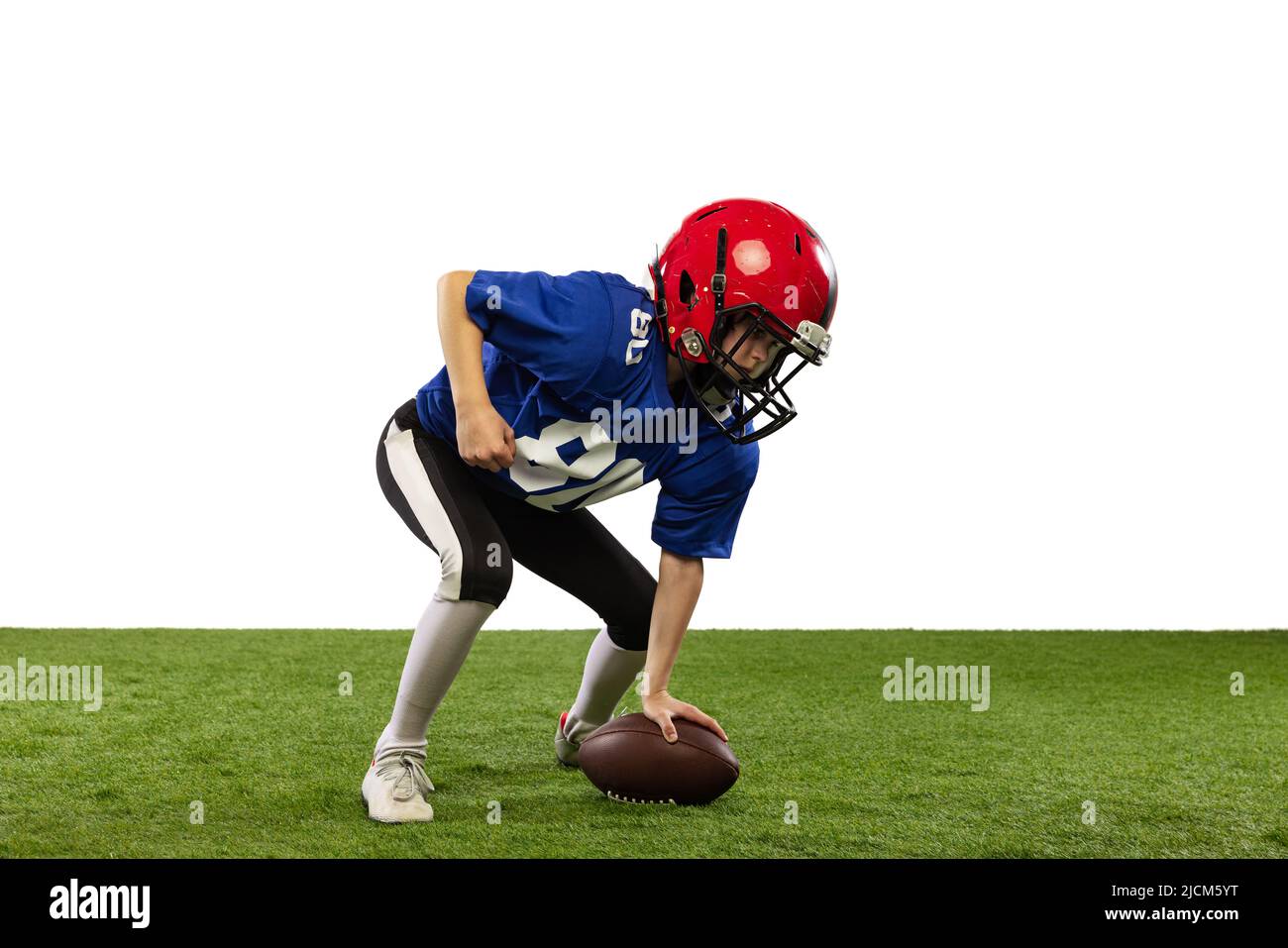 Athletic kid, beginner american football player in sports uniform and ...