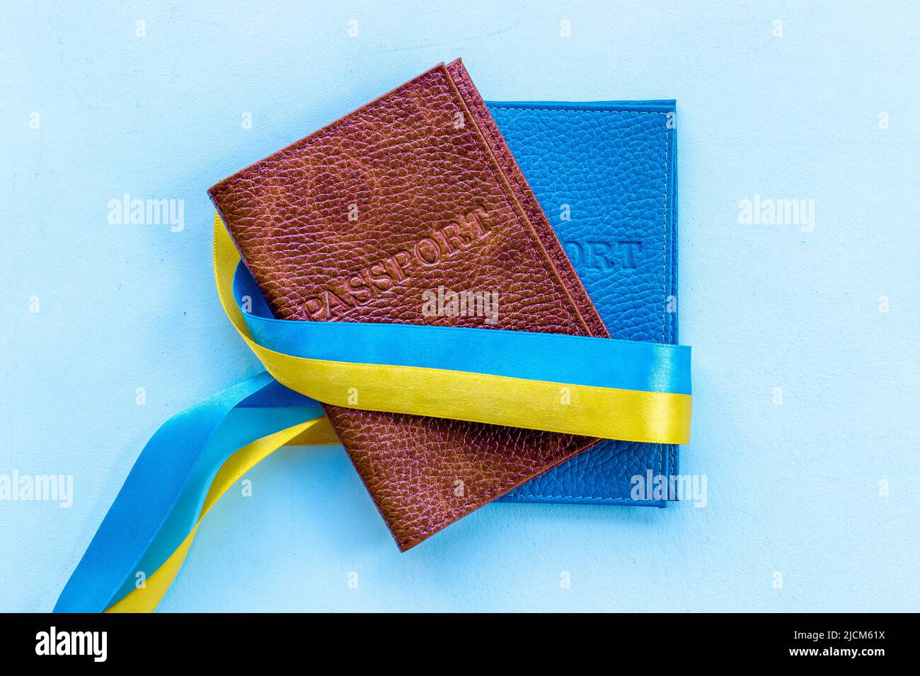 Yellow and blue ribbon with passport. Ukrainian immigration concept ...
