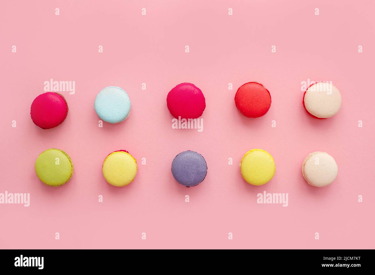 Colourful french macaroons or macaron on pink background, Dessert ...