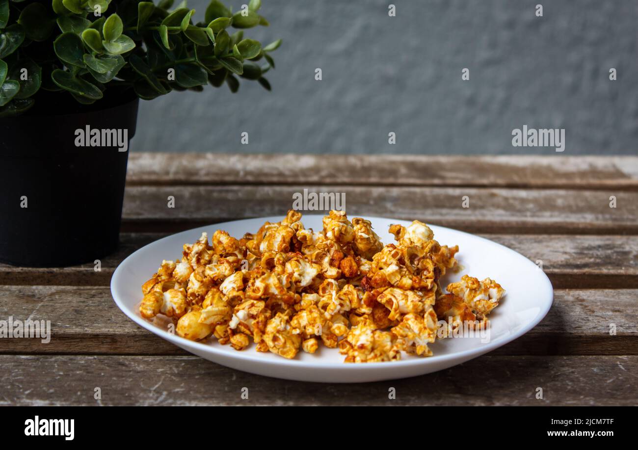 Crunchy and yummy sweet caramel popcorn in a plate. Caramel flavored ...