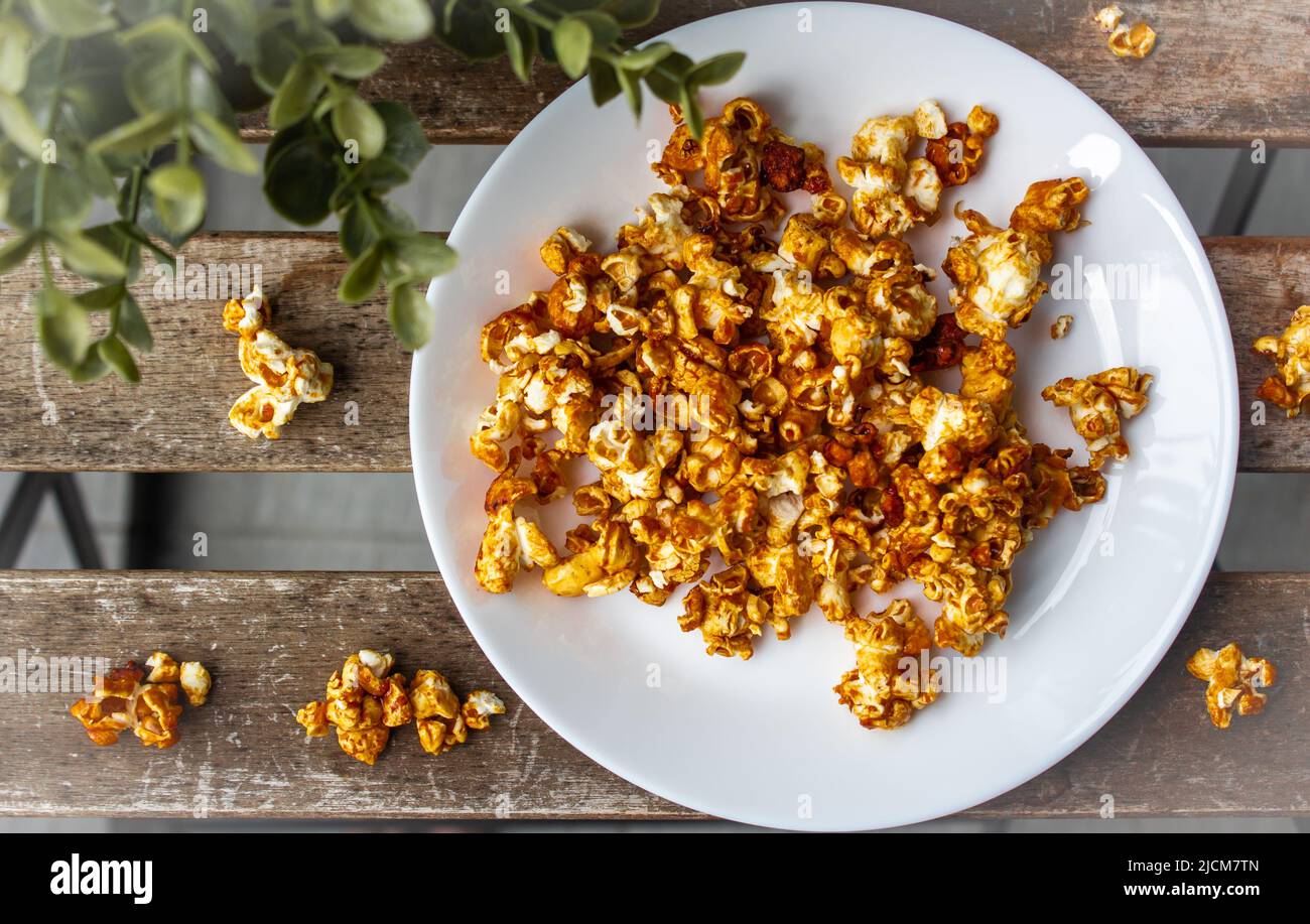 Sweet and crunchy caramel popcorn in a plate. Caramel flavored popcorn ...