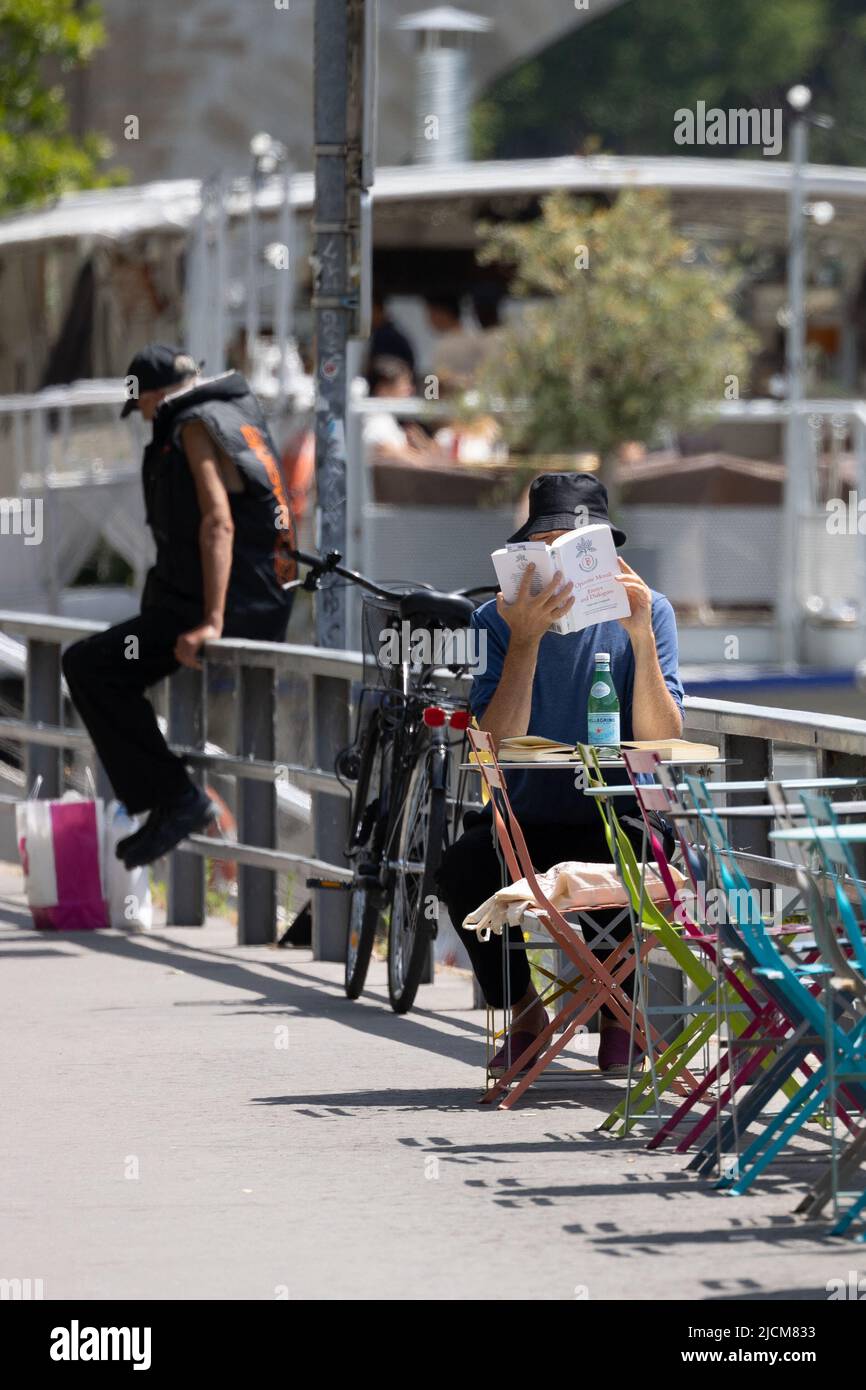 Paris, France, June 14, 2022. People drink water from a plastic bottle ...