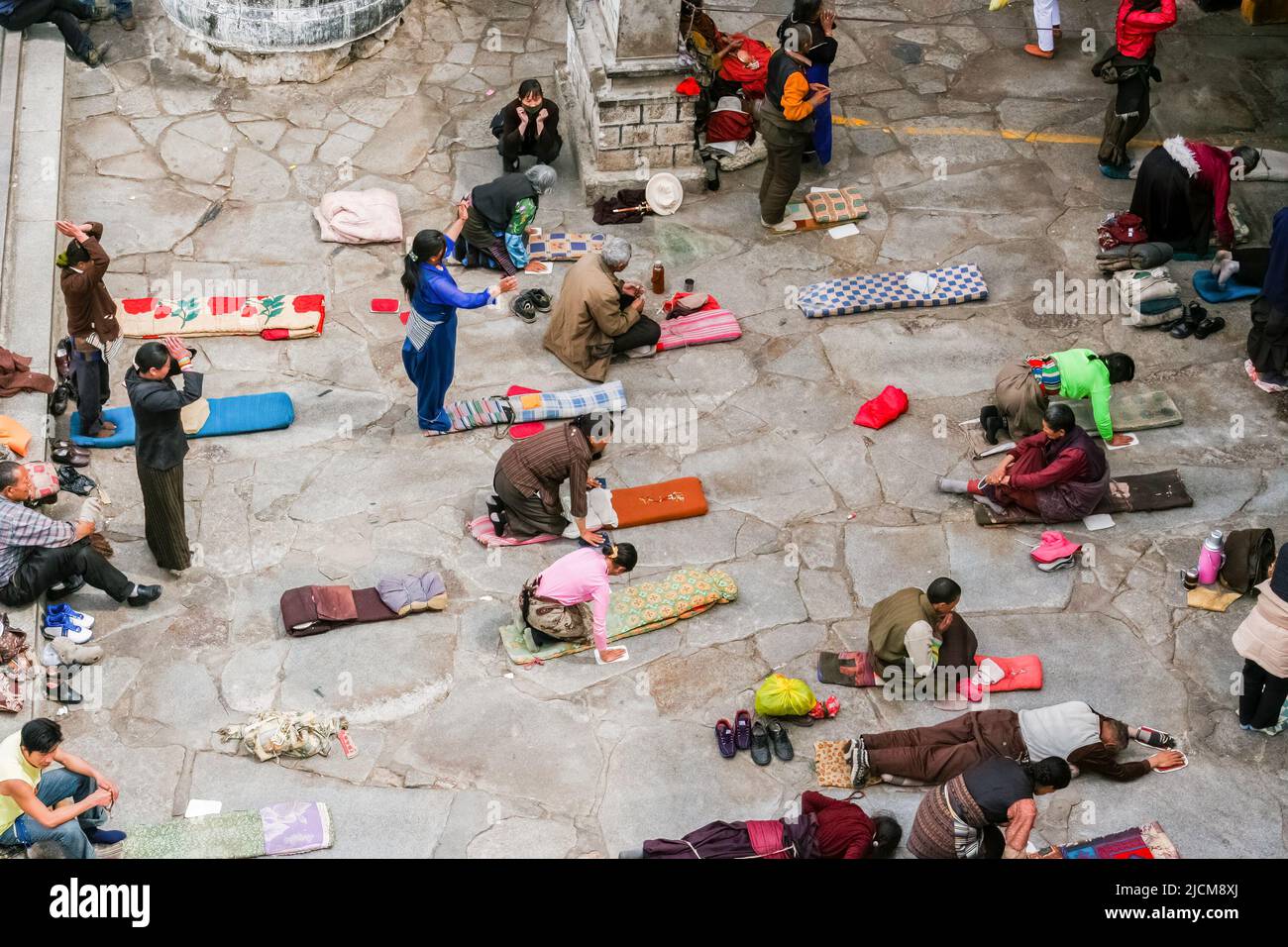 Tibetans on their spiritual pilgrimage prostrate themselves as they ...