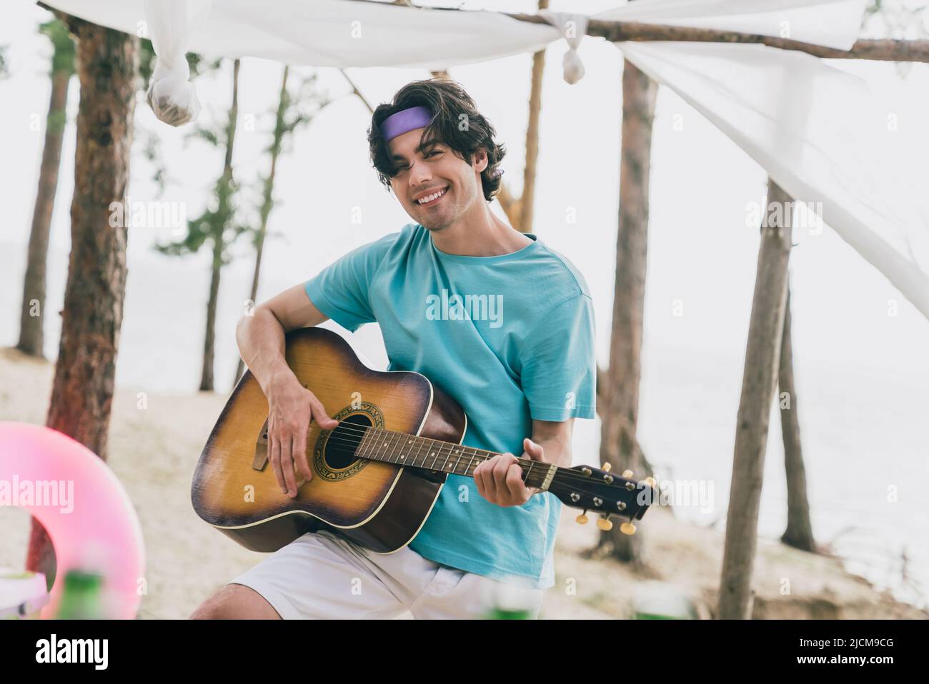 Portrait of attractive cheerful guy playing guitar relax enjoying good ...