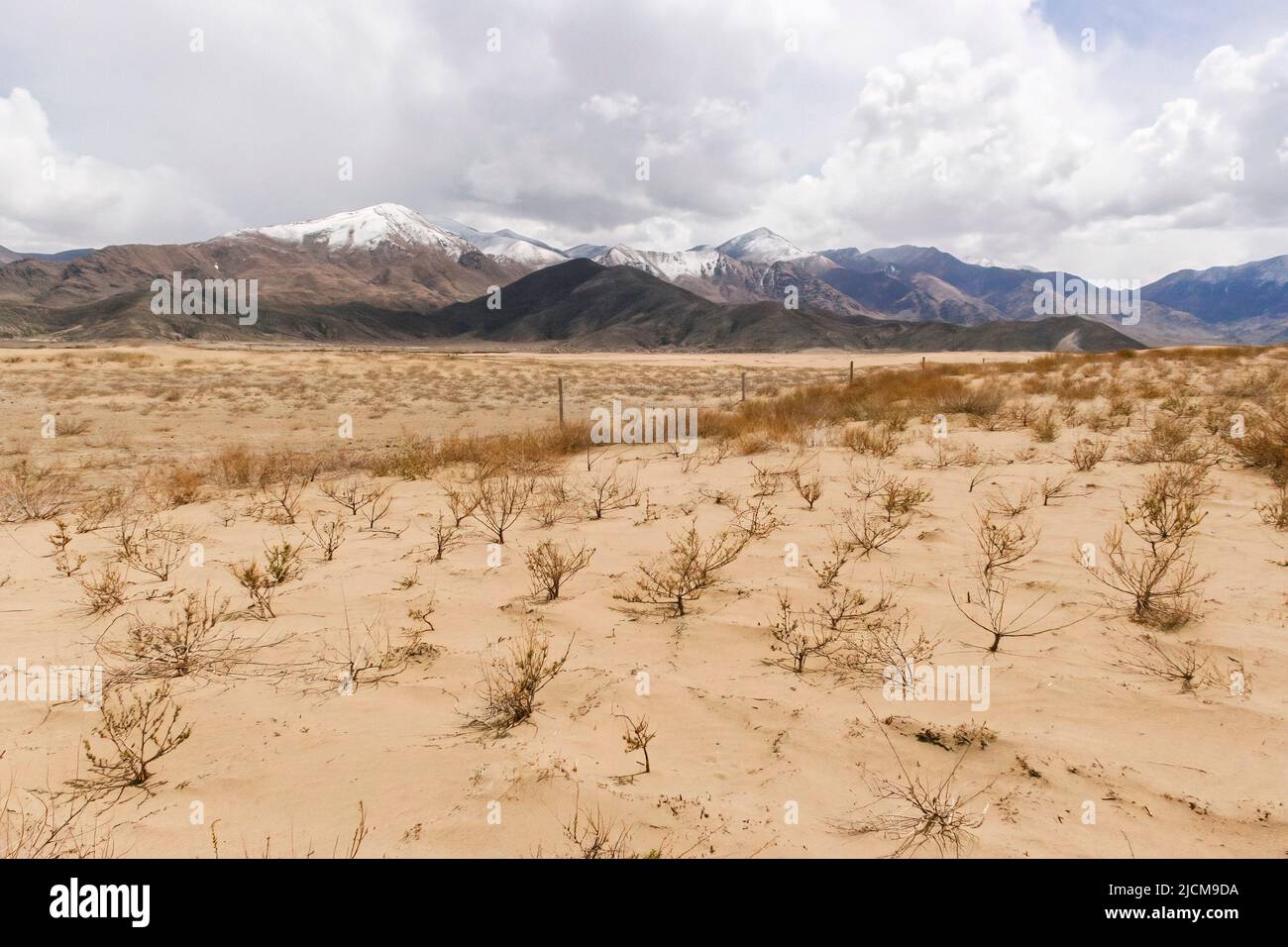 A barren place with Nyenchen Tanglha Mountains in the background Stock ...