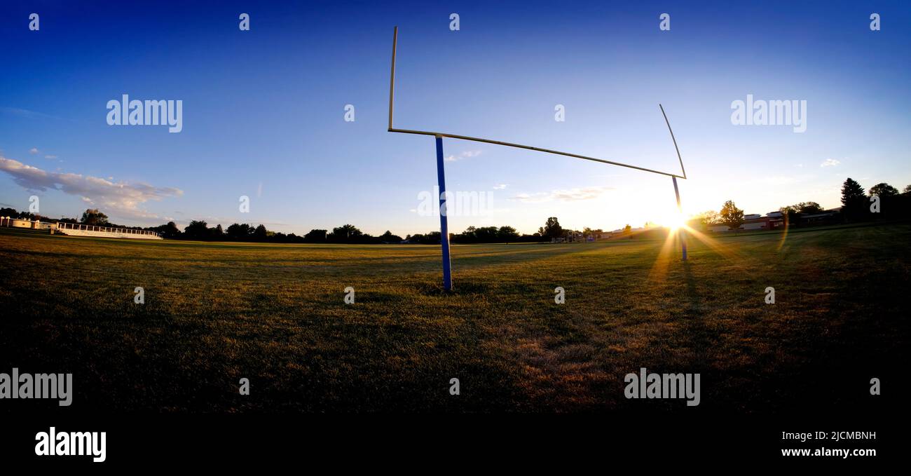 Football goalposts goal posts uprights at sunset with sun sky and ...