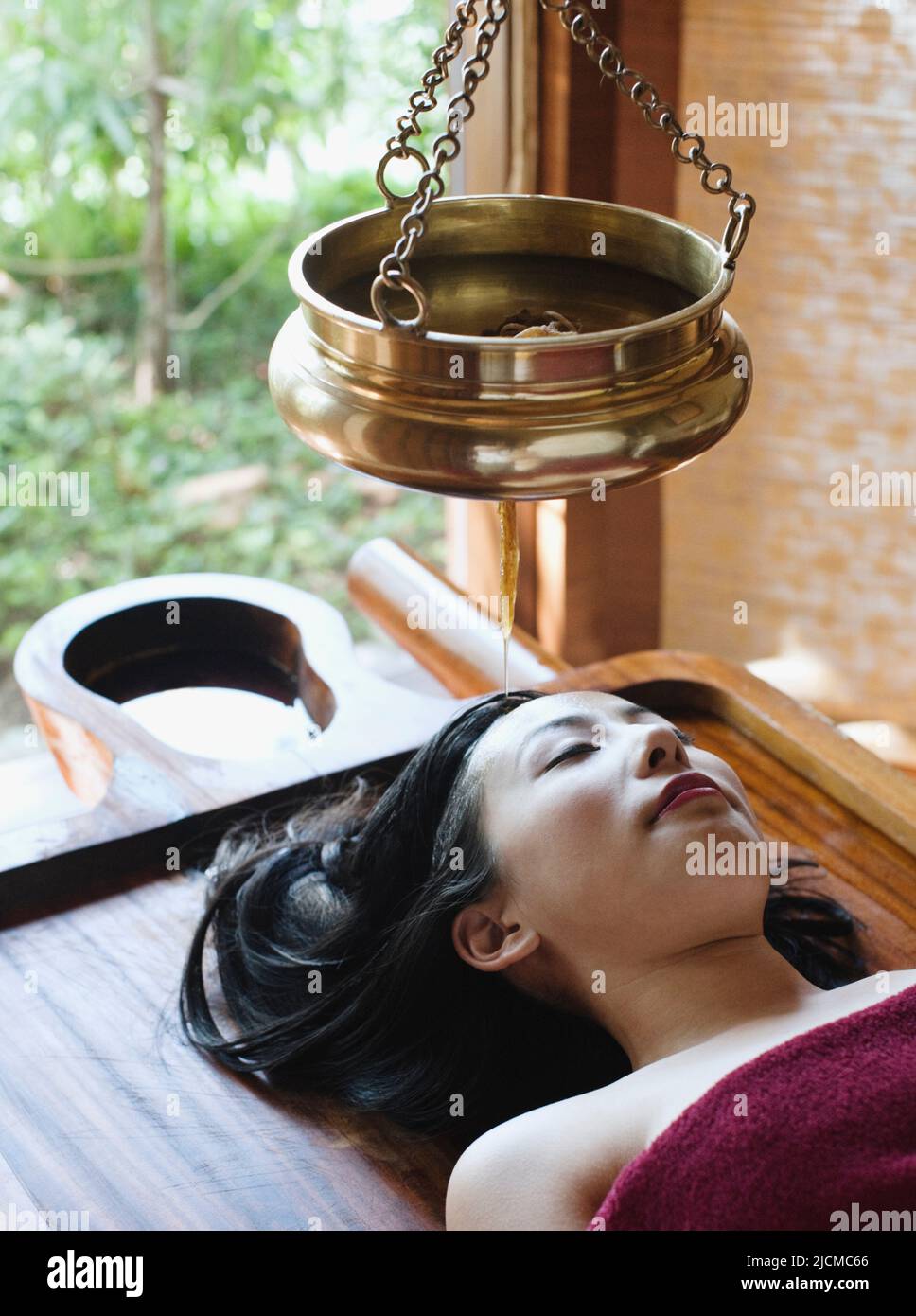 A Woman Receives a Shirodhara Ayurvedic Treatment Stock Photo - Alamy