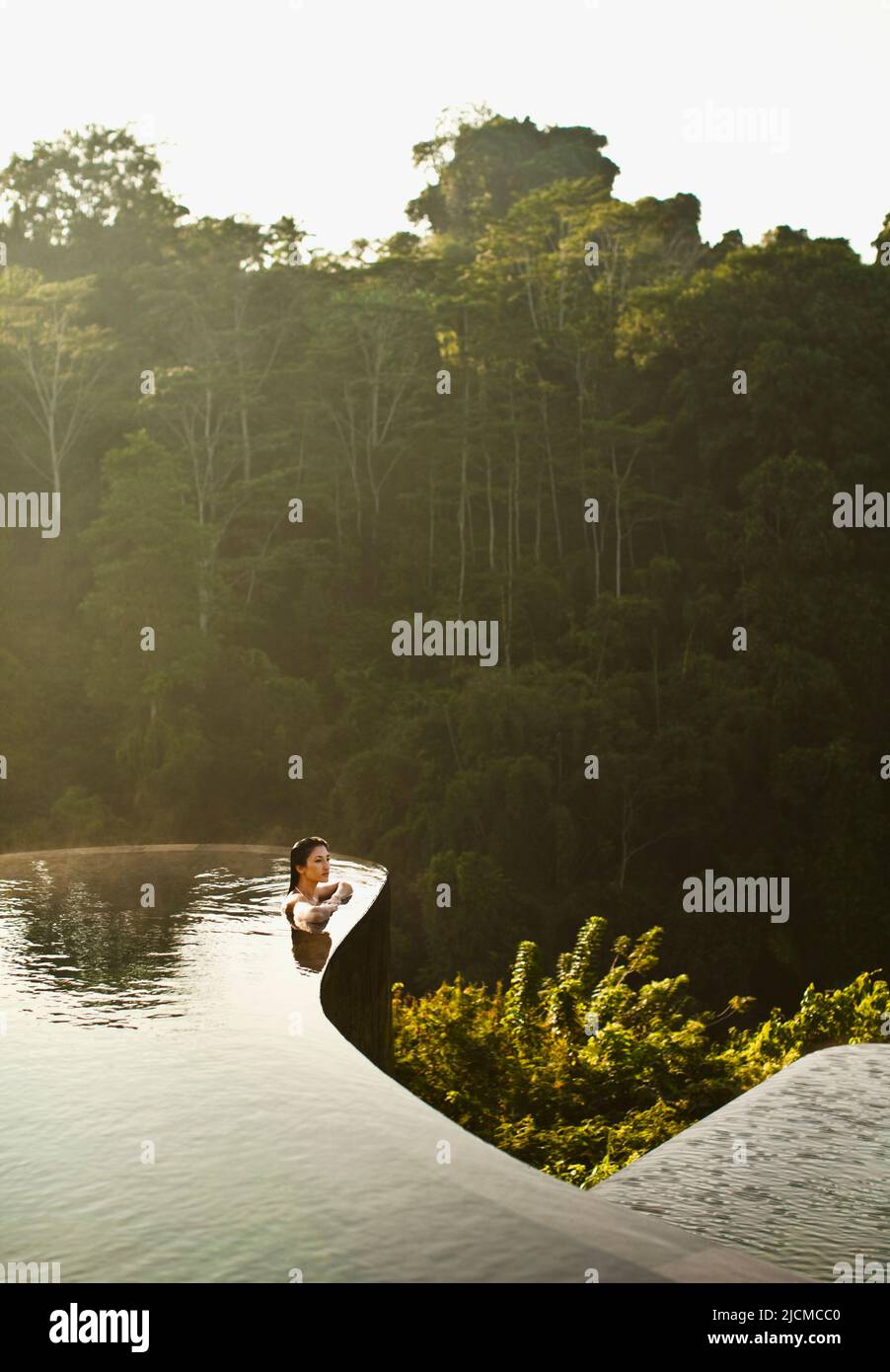 Female guest in two-tier infinity pool at Ubud Hanging Gardens, Bali ...