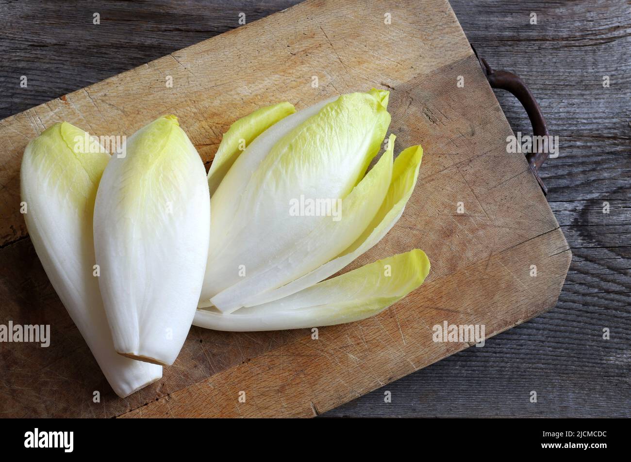 Group of raw endives on a wooden background Stock Photo - Alamy