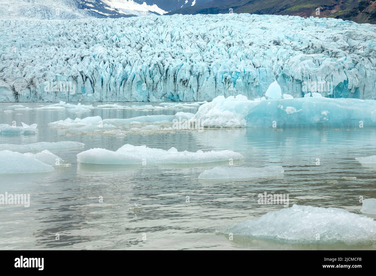 Ice wall and icebergs in Fjallsarlon glacier lagoon, abstract landscape ...